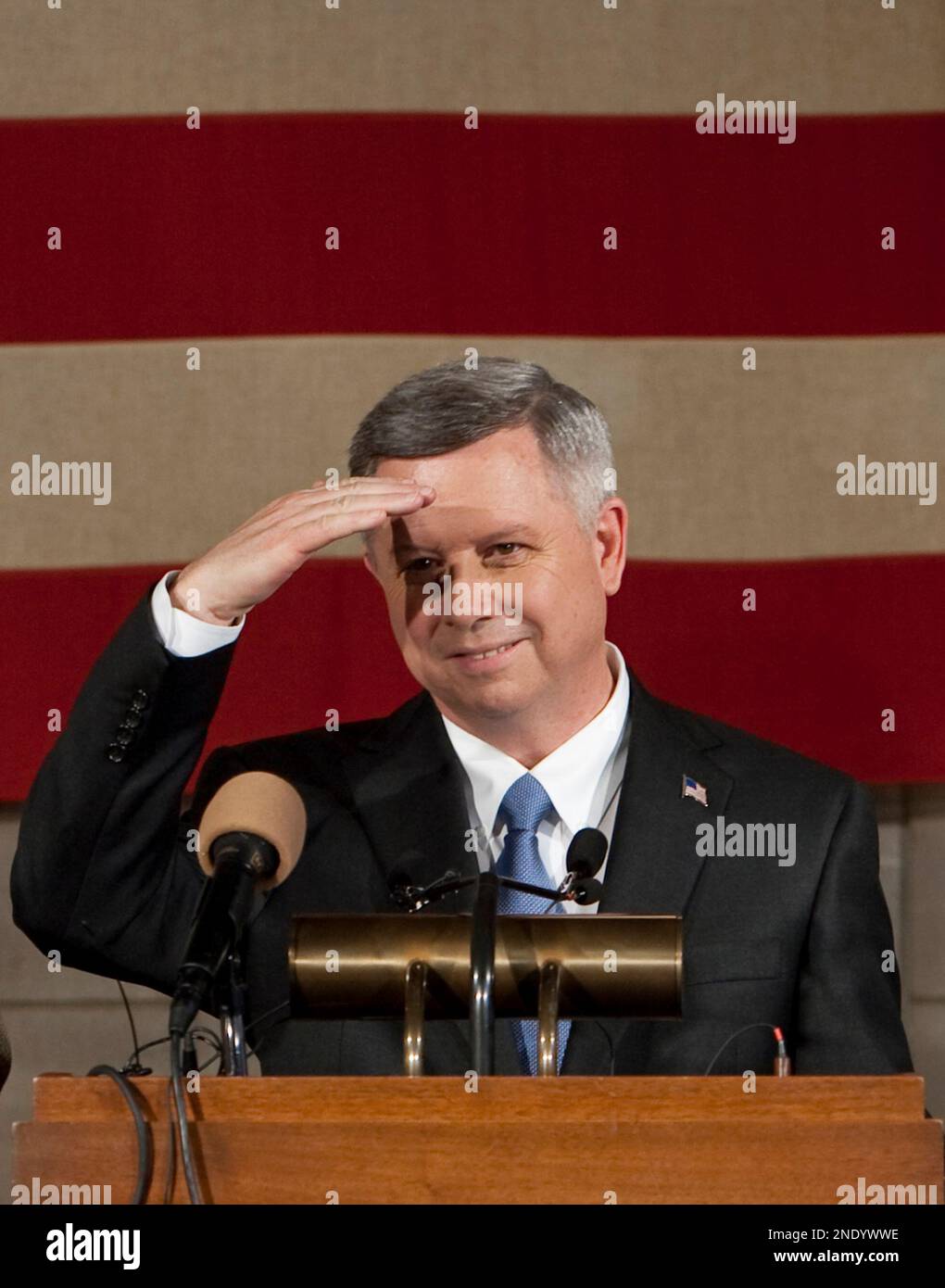 Nebraska Gov. Dave Heineman shields his eyes from bright lights as he ...