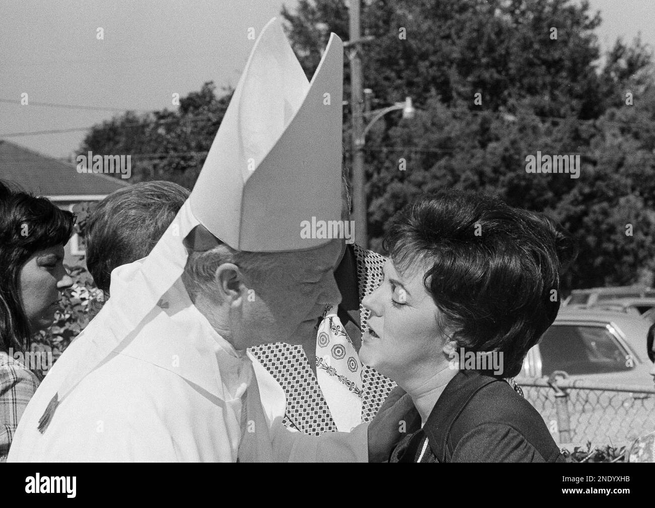 Archbishop Philip Hannan leans in to comfort grieving Mrs. J.C. Weber ...