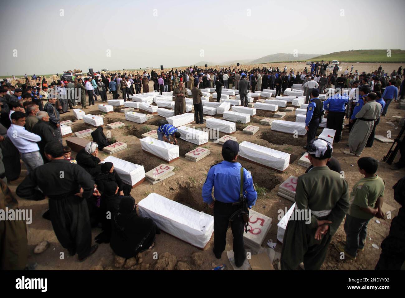 Mourners gather around the coffins of 107 Kurdish prisoners who died in ...
