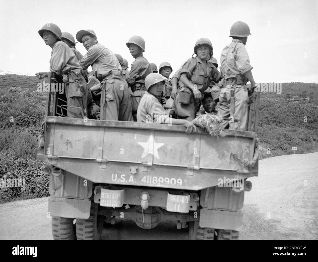 ROK soldiers look back at their former positions as their truck moves ...