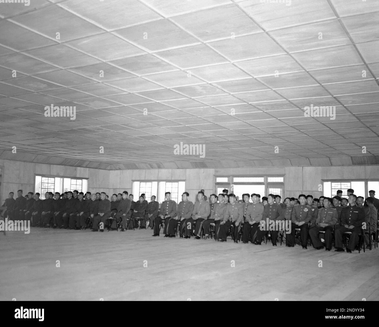 Witnesses on the Communist side of Armistice Hall primly sit in place ...