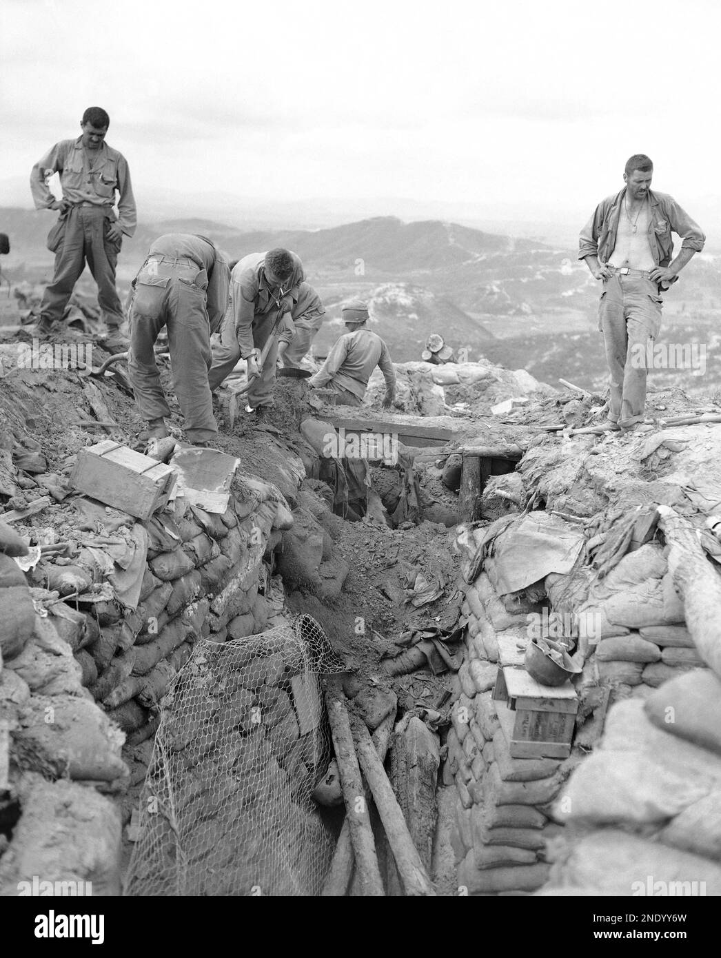 U.S. 2nd infantry division soldiers tear down bunkers and fill up ...