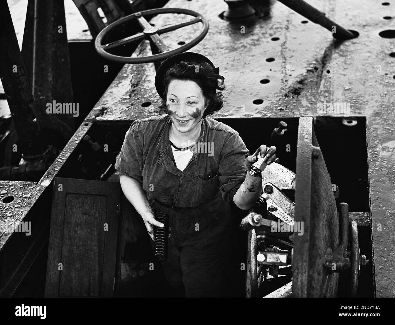 A Wren leaves a submarine at a British Naval Base, somewhere in England ...