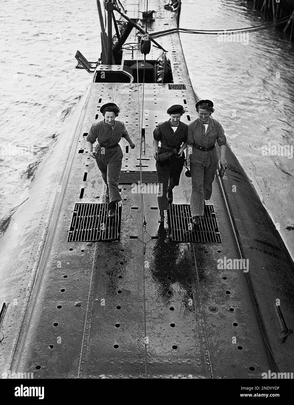 Three of the Wren leaves a submarine at a British Naval Base, somewhere ...