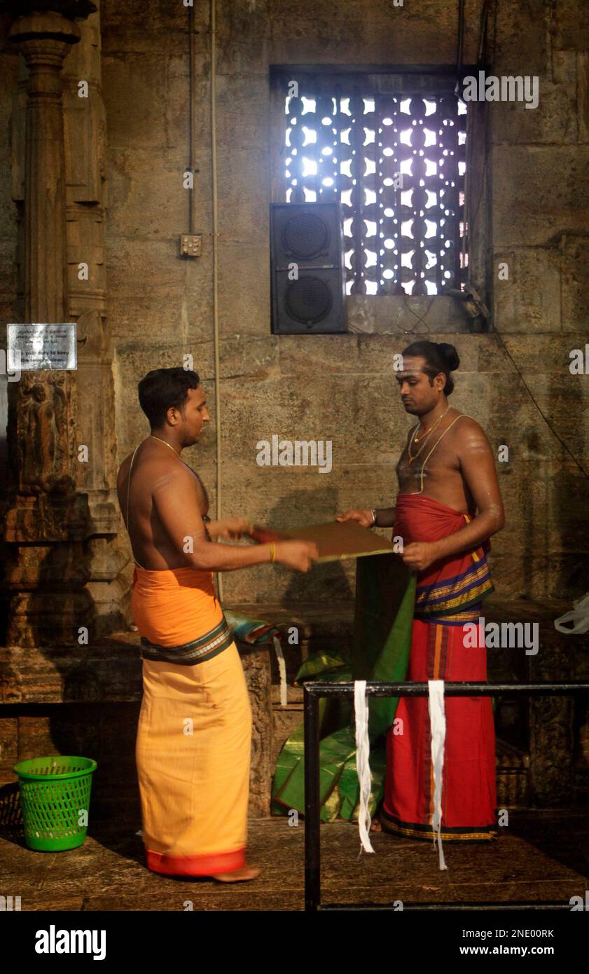 Sri Lankan Tamil Hindu priests fold a piece of cloth on the last day of ...