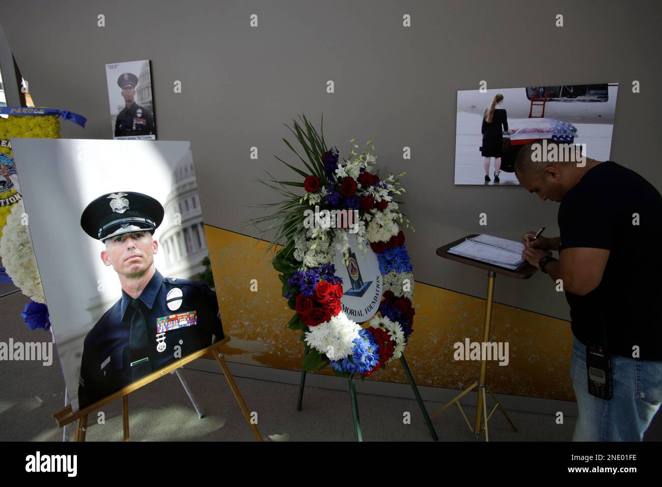 Los Angeles Police officers sign a regertry during the memorial service ...