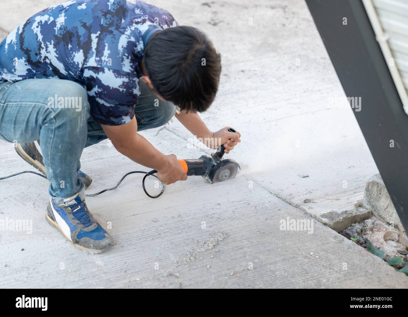 Worker use stone grinding machine cut floor for tube embeded Stock ...