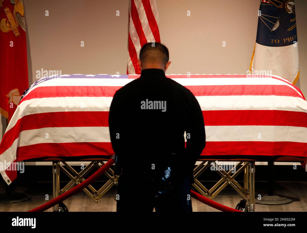 An unidentified Los Angeles police officer pays his respect during a ...