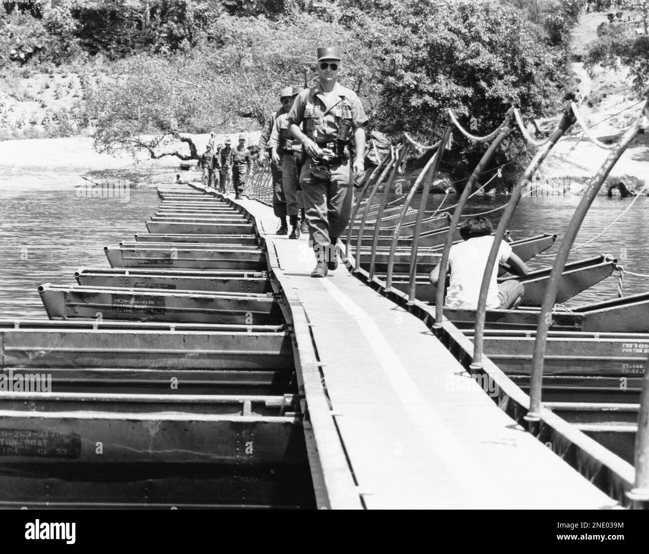 An American adviser leads South Vietnamese over a new Pontoon Bridge ...
