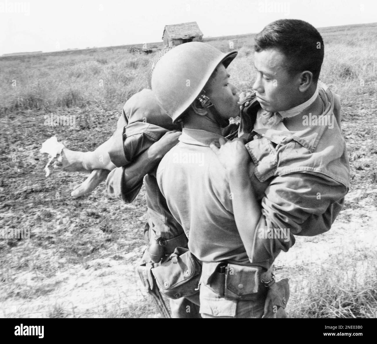 A Vietnamese soldier carries his comrade from battle after government ...