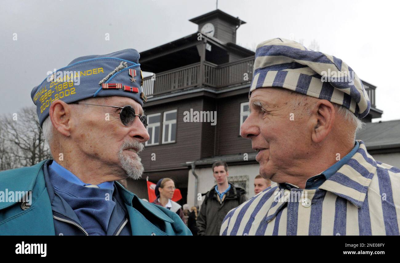 Nazi concentration camp survivor Viktor Savytskyi of Ukraine, right, reacts with US army veteran ...