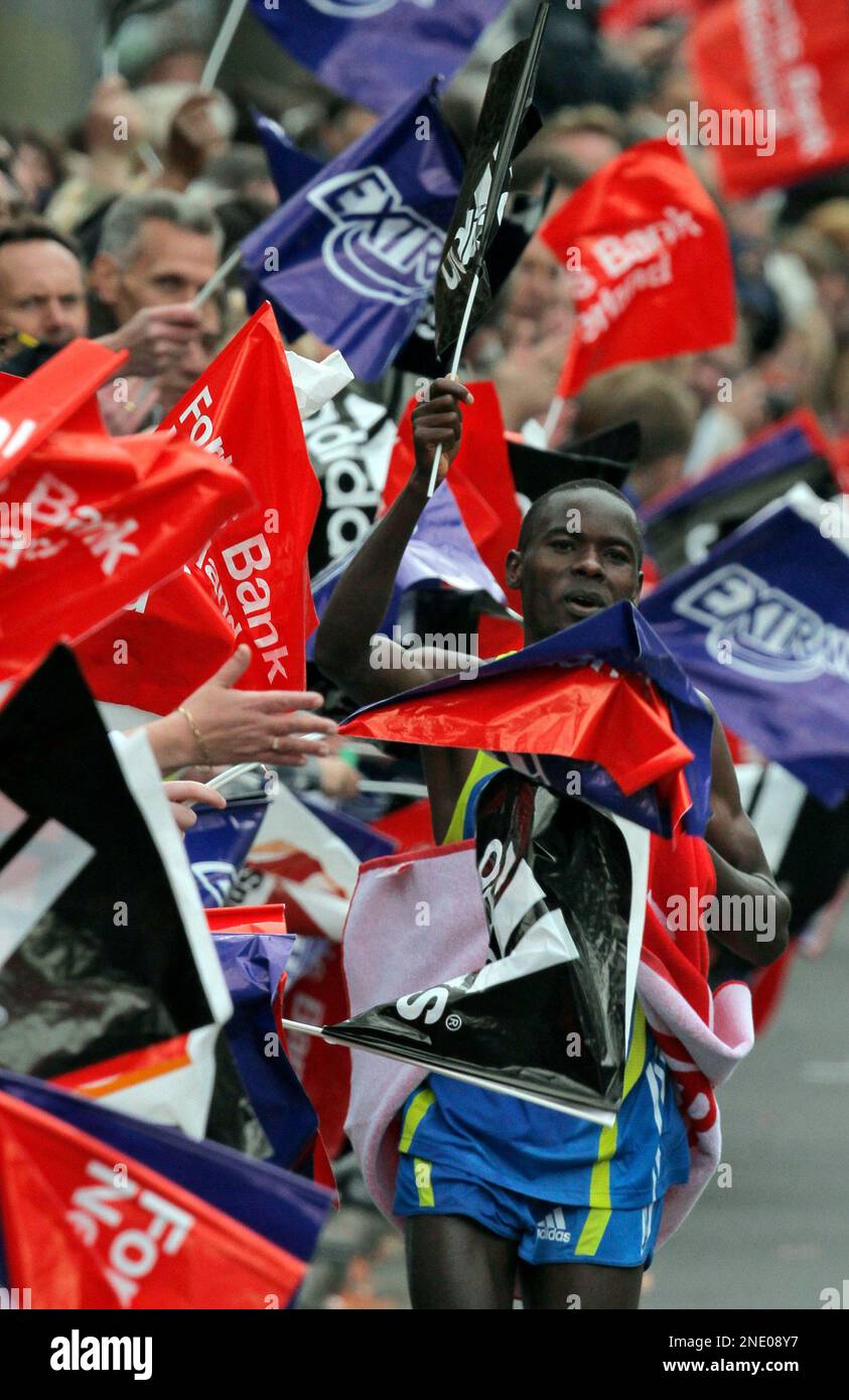 Patrick Makau of Kenya reacts with the crowd after crossing the finish ...