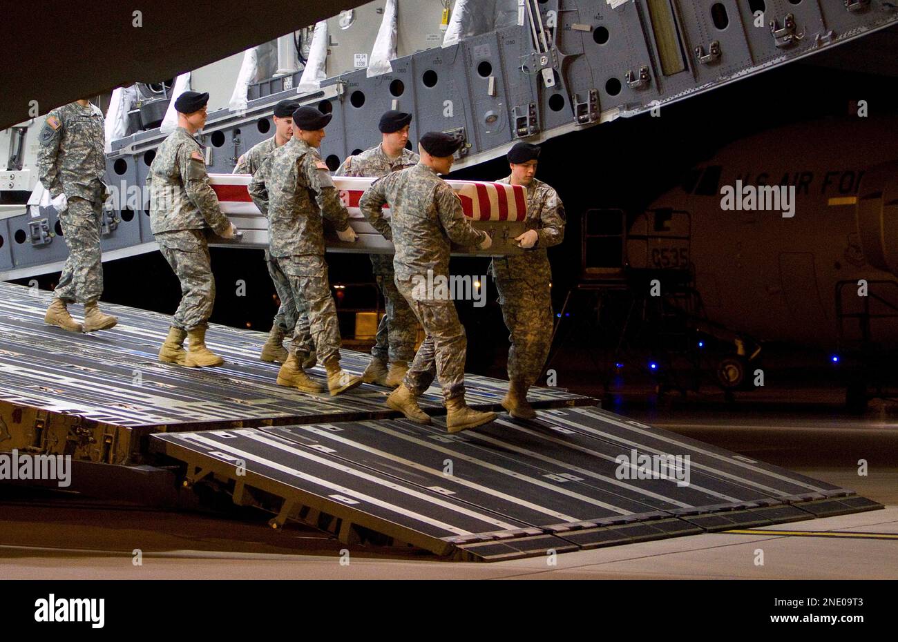 An Army carry team carries a transfer case containing the remains of ...