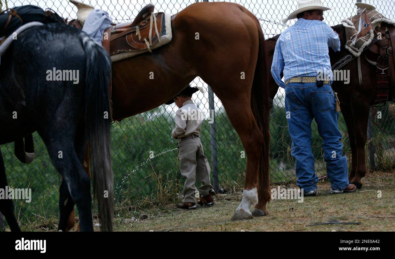 A boy relieves himself on the sidelines of an event commemorating the ...