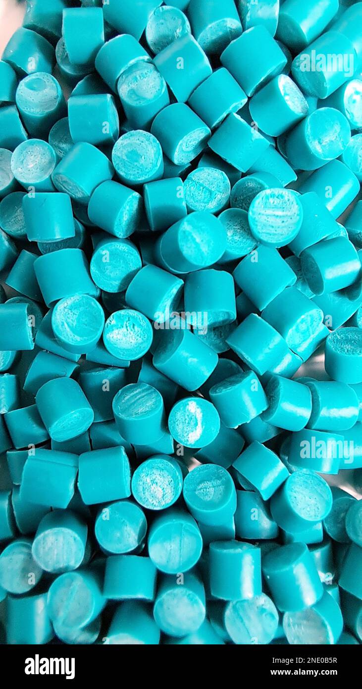 Plastic Polymer Granules close-up background turquoise color. High ...