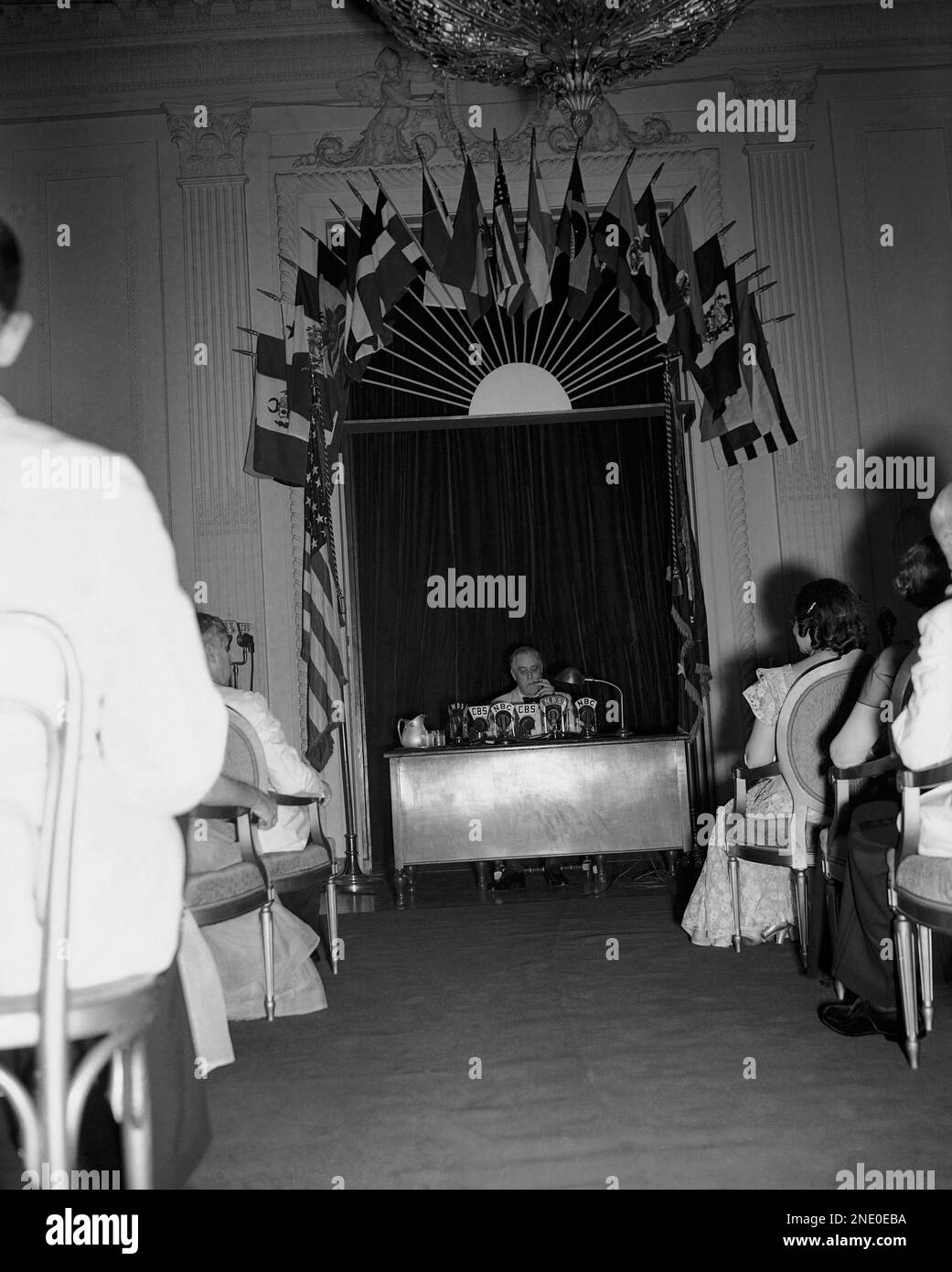 Beneath an ARC of the flags of the American republics, President ...