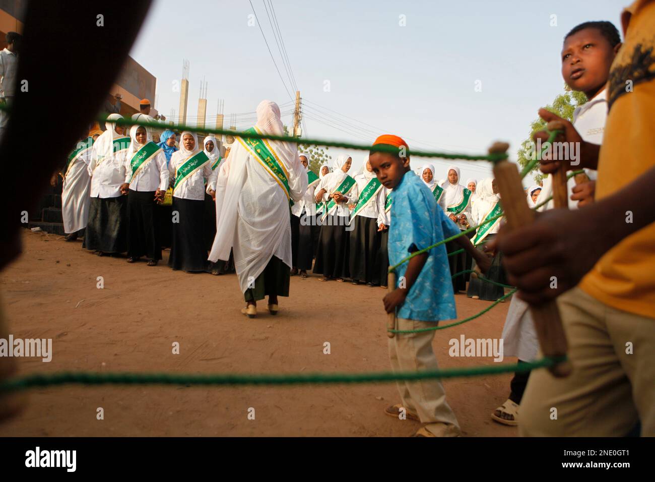 Sudanese Muslim boys use ropes to secure women during a parade of the ...