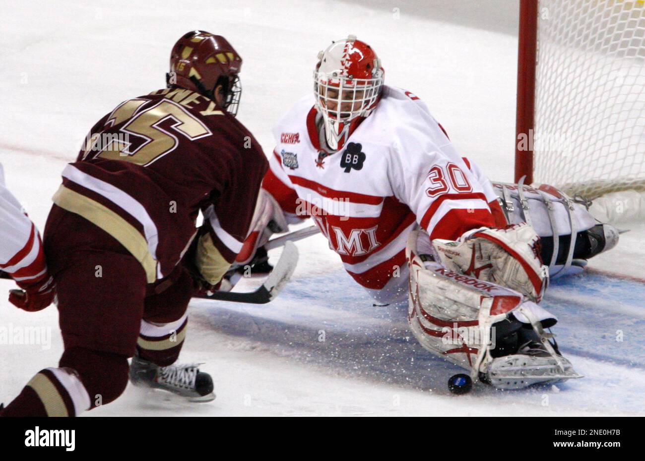 Miami of Ohio goalie Cody Reichard (30) deflects a shot by Boston ...