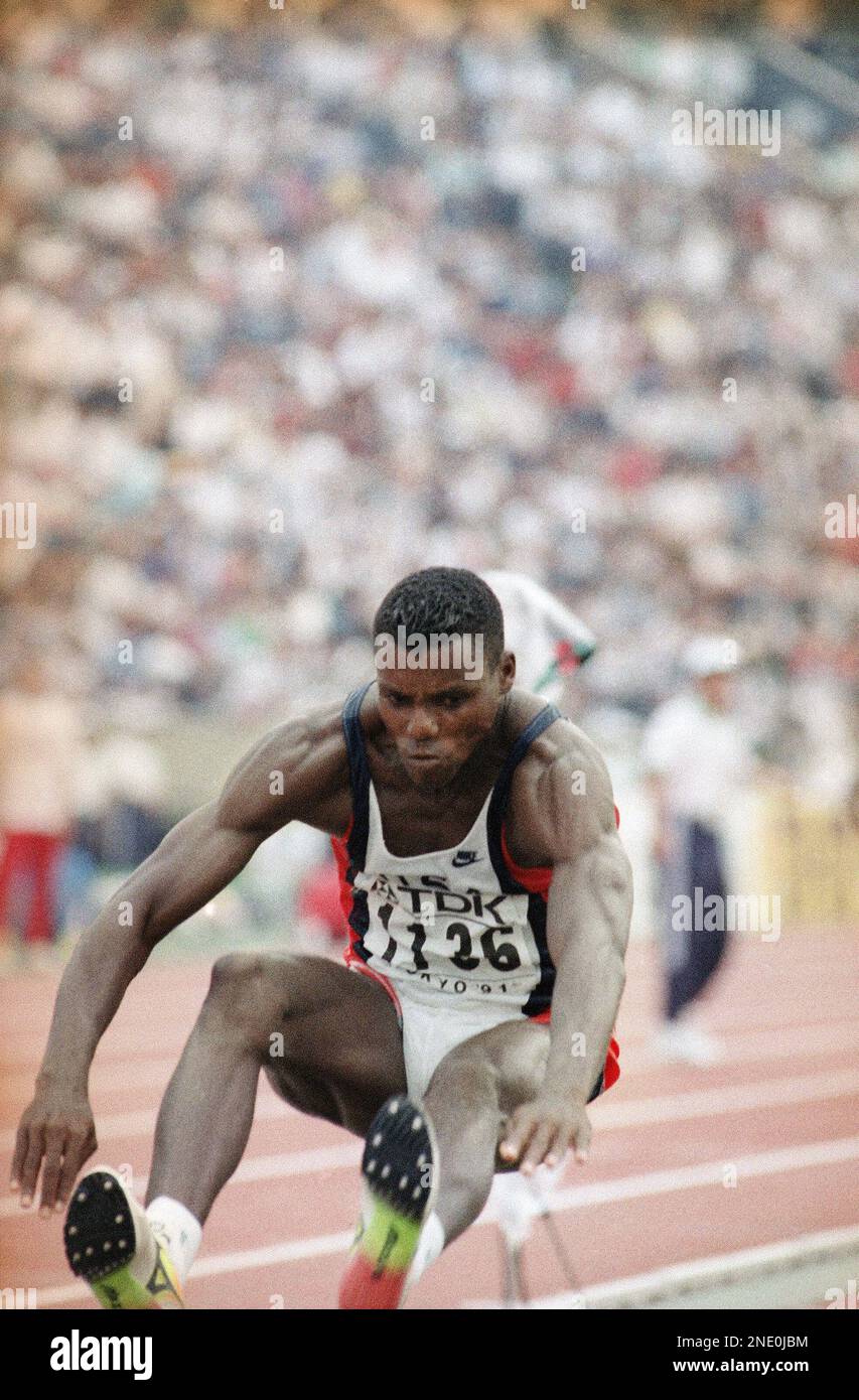 Sprint world champion Carl Lewis leaps in the long jump qualifying ...