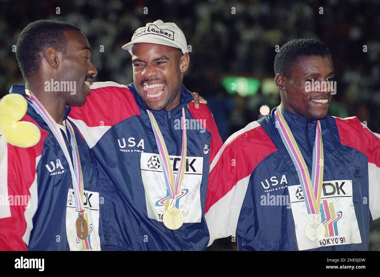 Mike Powell, center, of the U.S., wears the gold medal after setting a ...