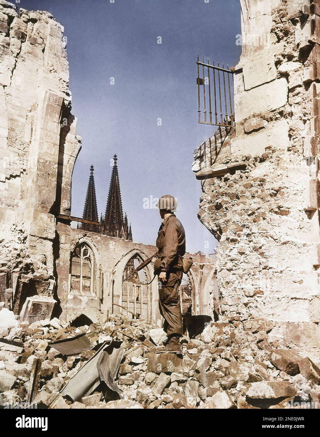 Pvt. Hershel L. Brookey of Hugo, Okla., stands amid ruins in city of ...