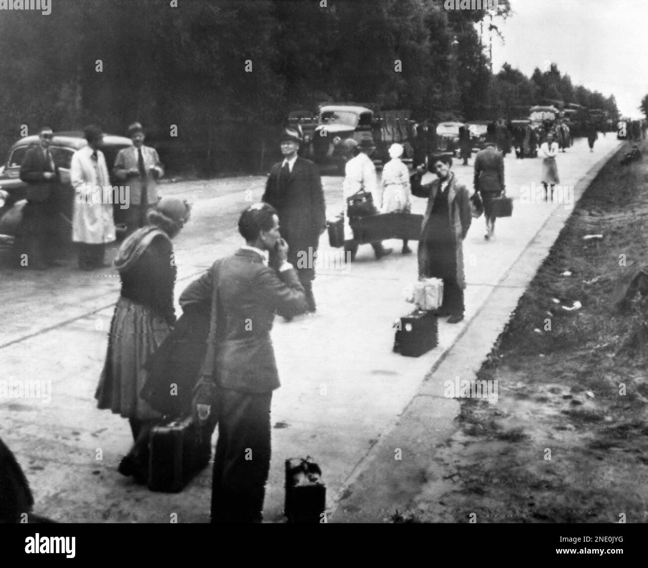 German pedestrians and vehicles line the autobahn near Helmstedt ...