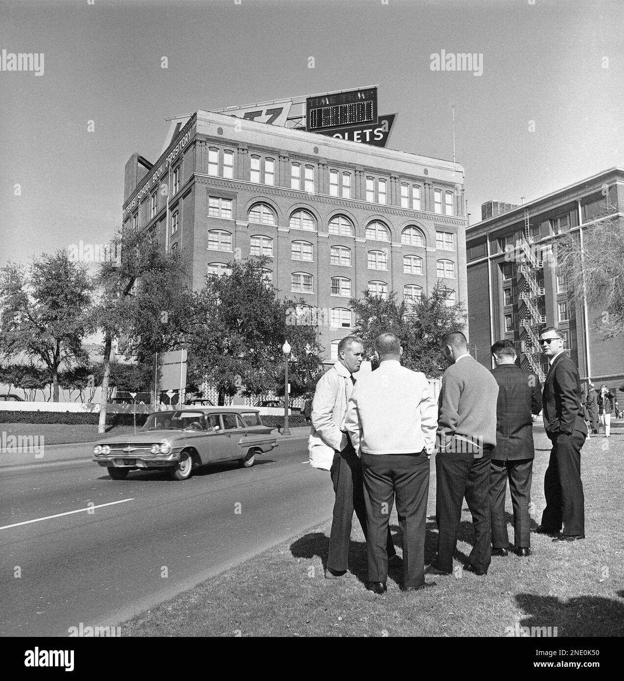 The clock atop the Texas School Book Depository flashed 12:30 p.m., in ...