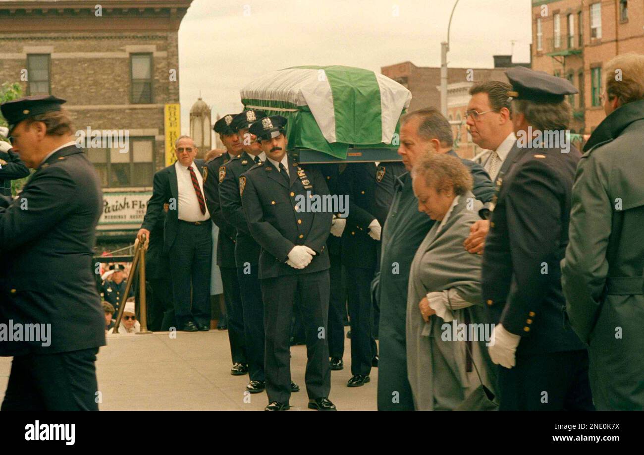 Martin Hoban, with his arm around his wife, Catina, right, walk past ...