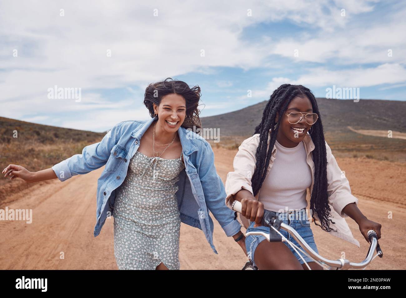 Bike, girl friends and happy road trip fun of women outdoor on a desert ...