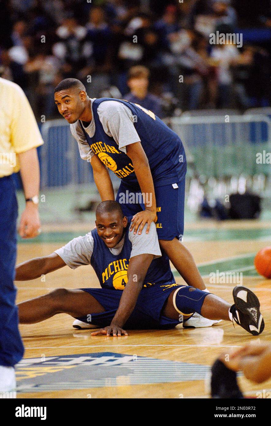 Michigan forward Chris Webber (4) and guard Jimmy King limber up during ...