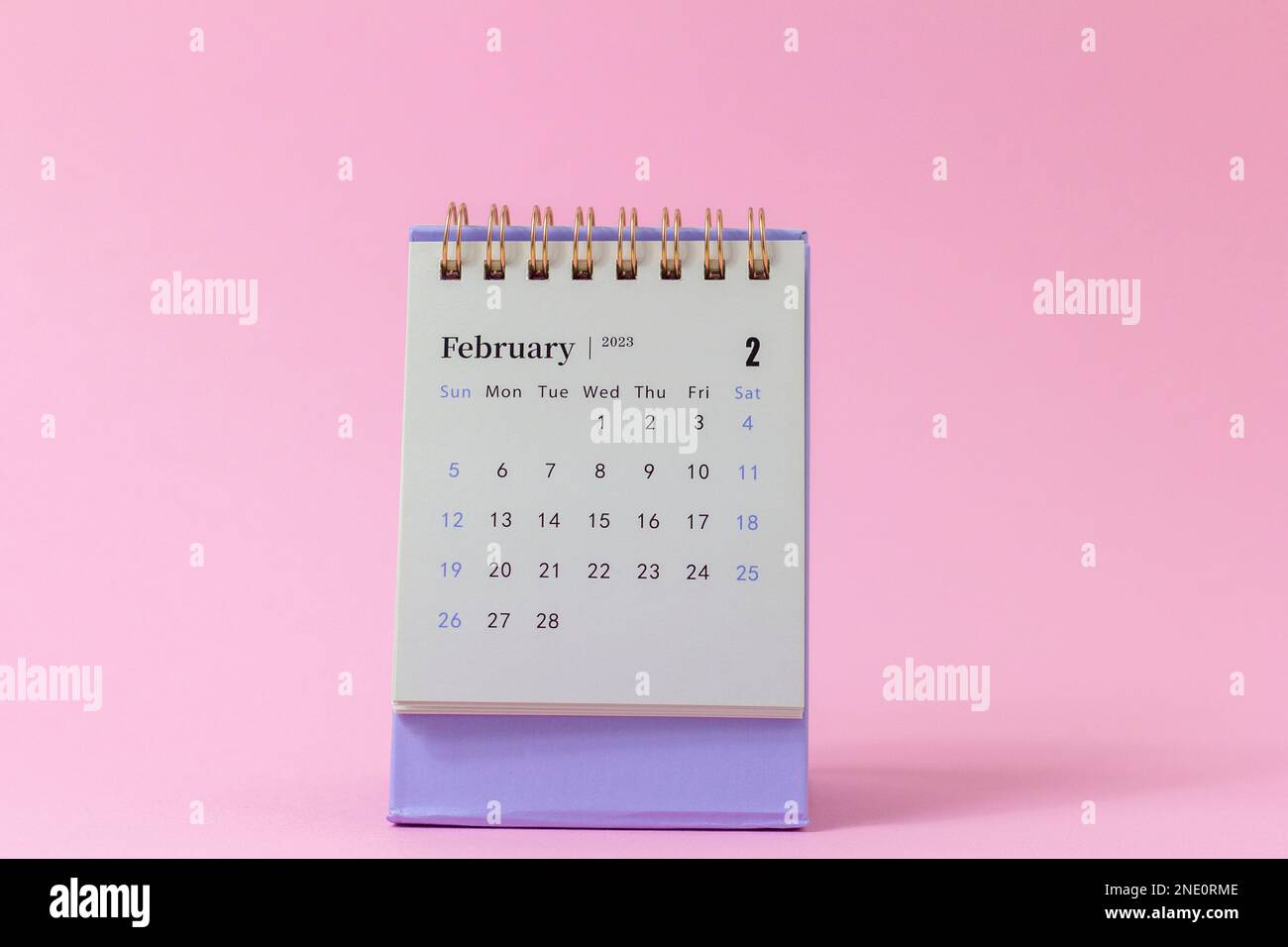 February 2023.Desktop calendar on pink background for planning and ...