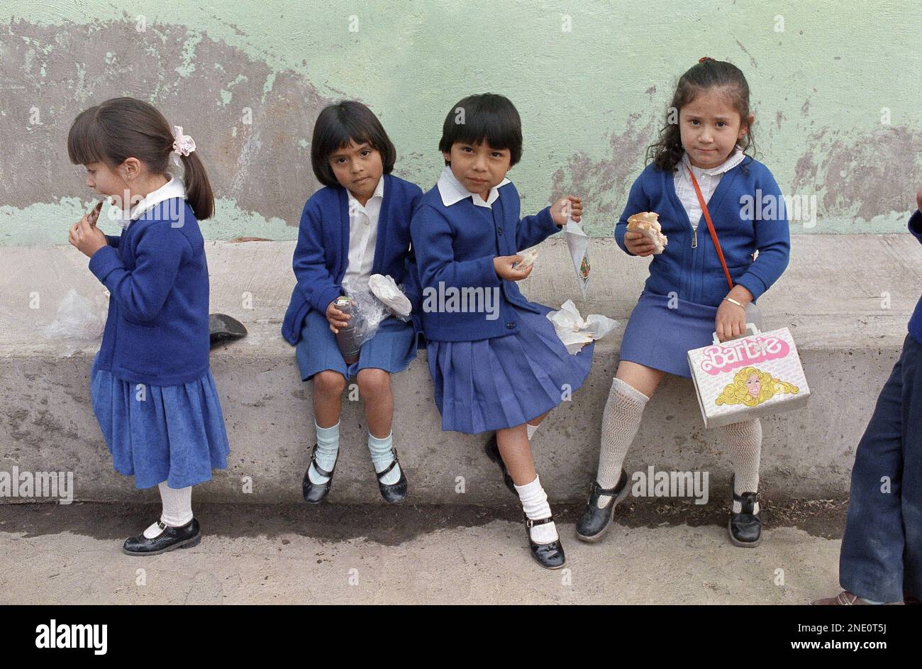 Four girls eat their lunches and walk outside El Pipila Public School ...