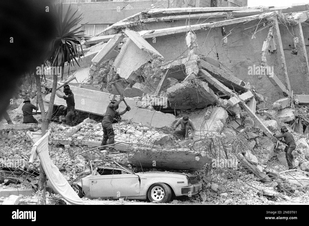 Rescue workers chip away at concrete from a toppled building, Sept. 21 ...
