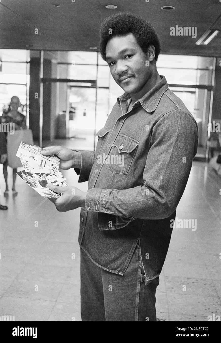 George Foreman looks over photos of his successful defense on Sept. 1 ...