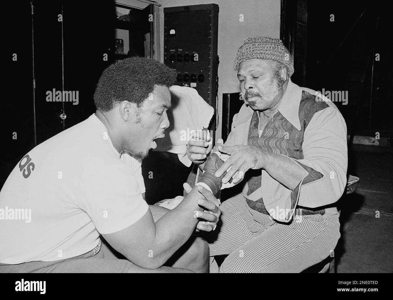 George Foreman can?t hold back a yawn as Archie Moore tapes his hands ...