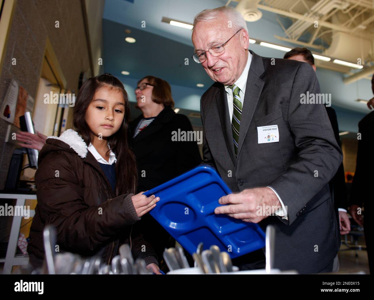 Eight-year-old Crystal Ojeda, left, hands a tray to Kevin Concannon ...