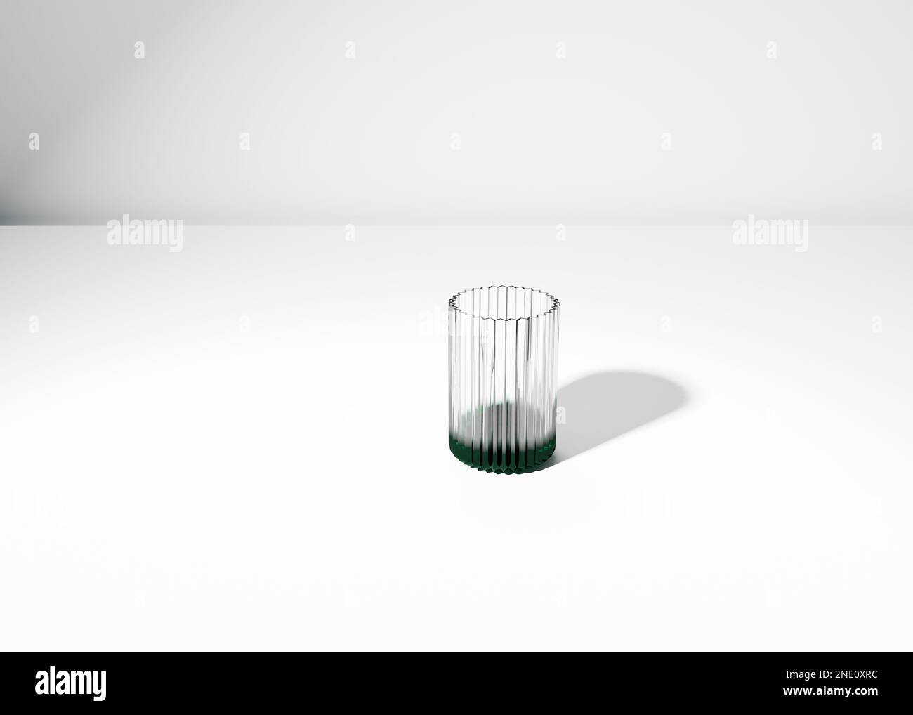 An Empty ribbed glass vase with a colored bottom on white studio ...
