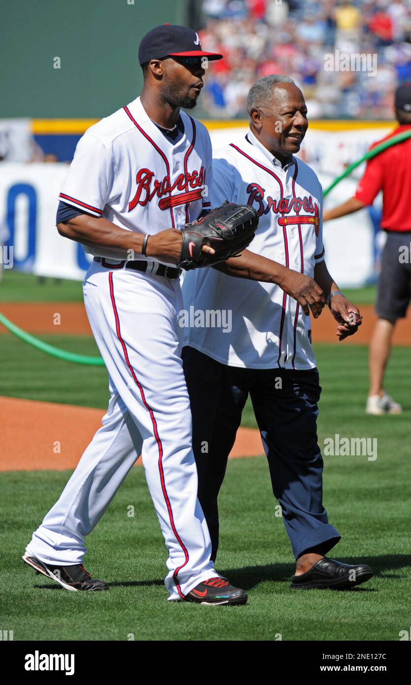 Atlanta Braves Hall of Famer Hank Aaron, right, walks off the field ...