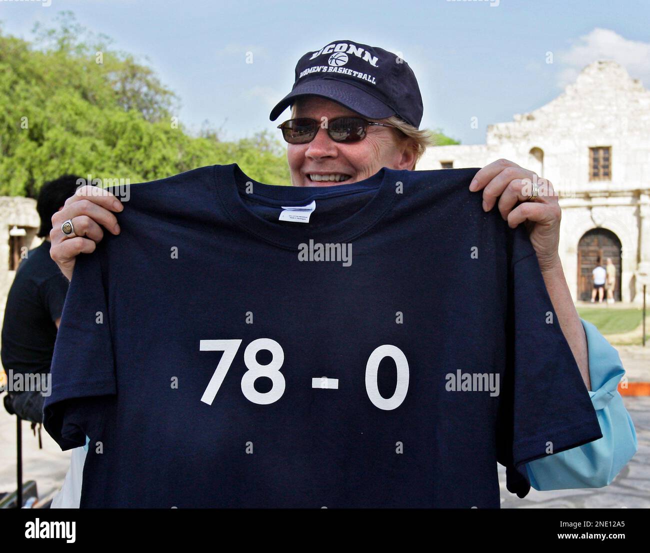 Connecticut fan Denise Early, from Tucson, Ariz., holds up a shirt ...