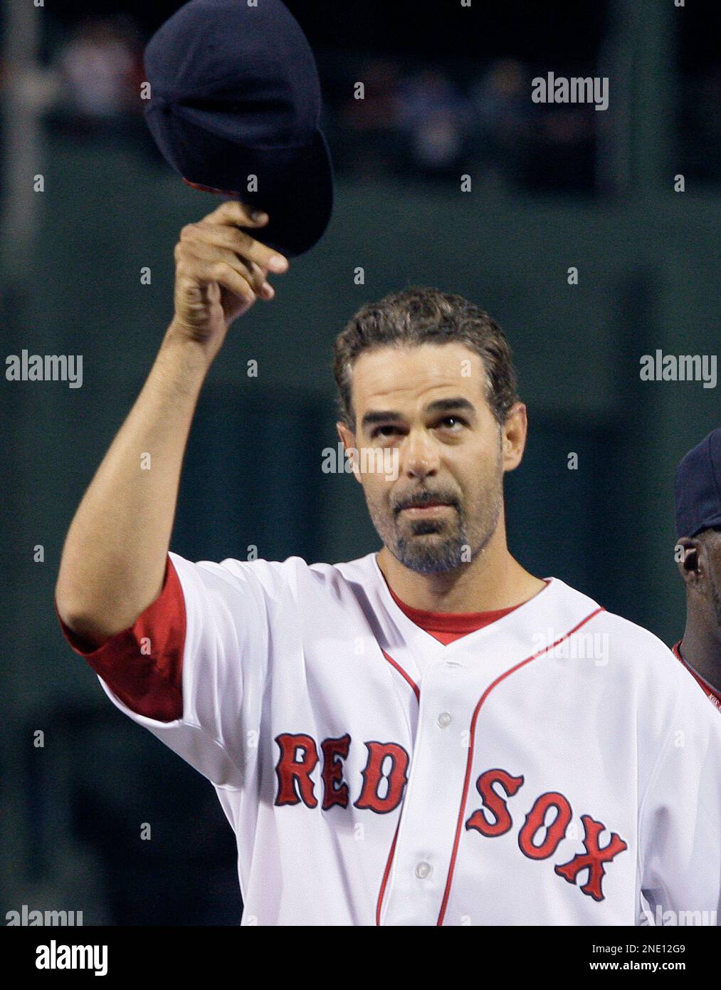 Boston Red Sox' Mike Lowell tips his cap to fans' cheers during pre ...