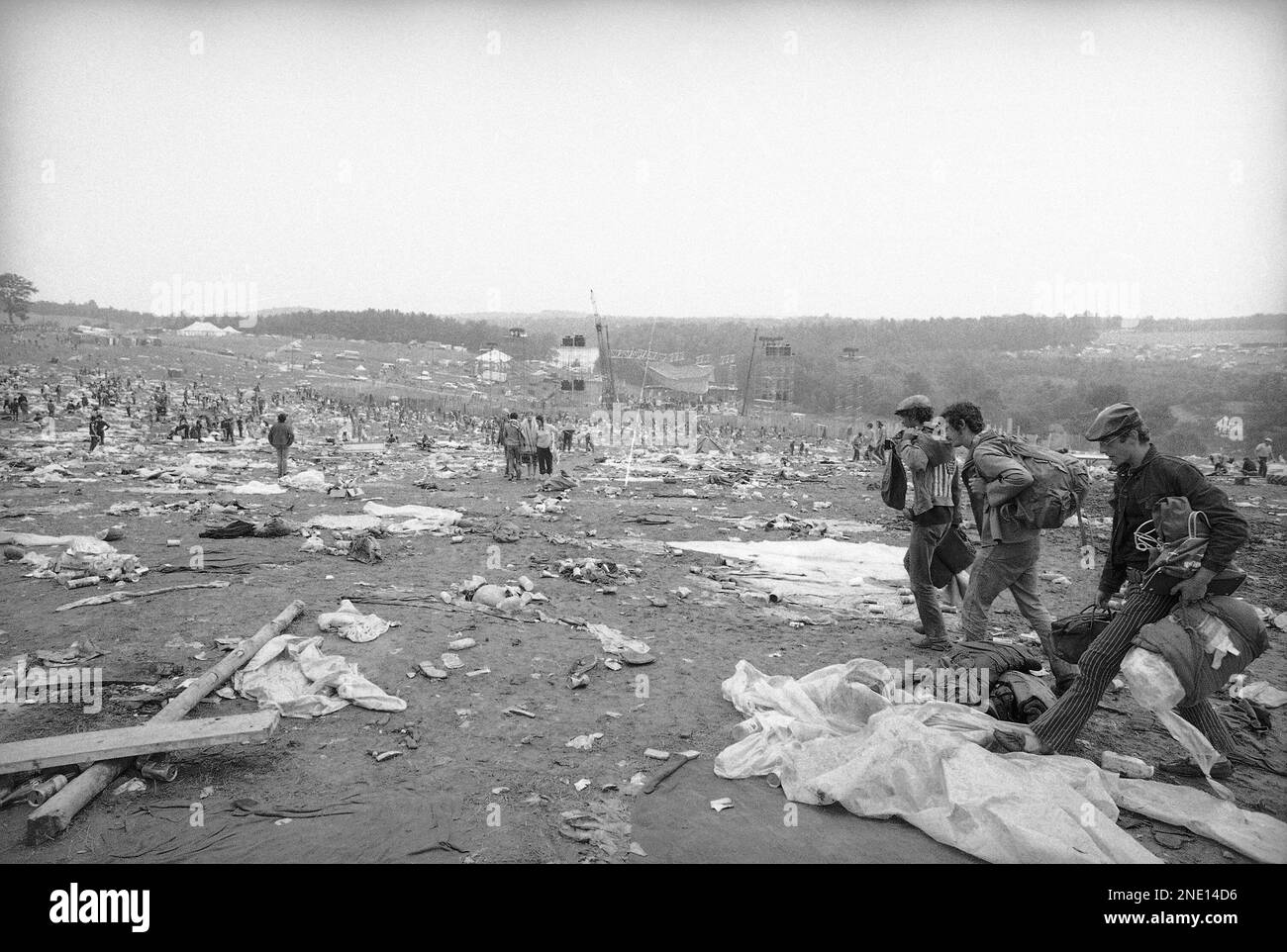 Young people leave the debris-strewn scene where hundreds of thousand ...