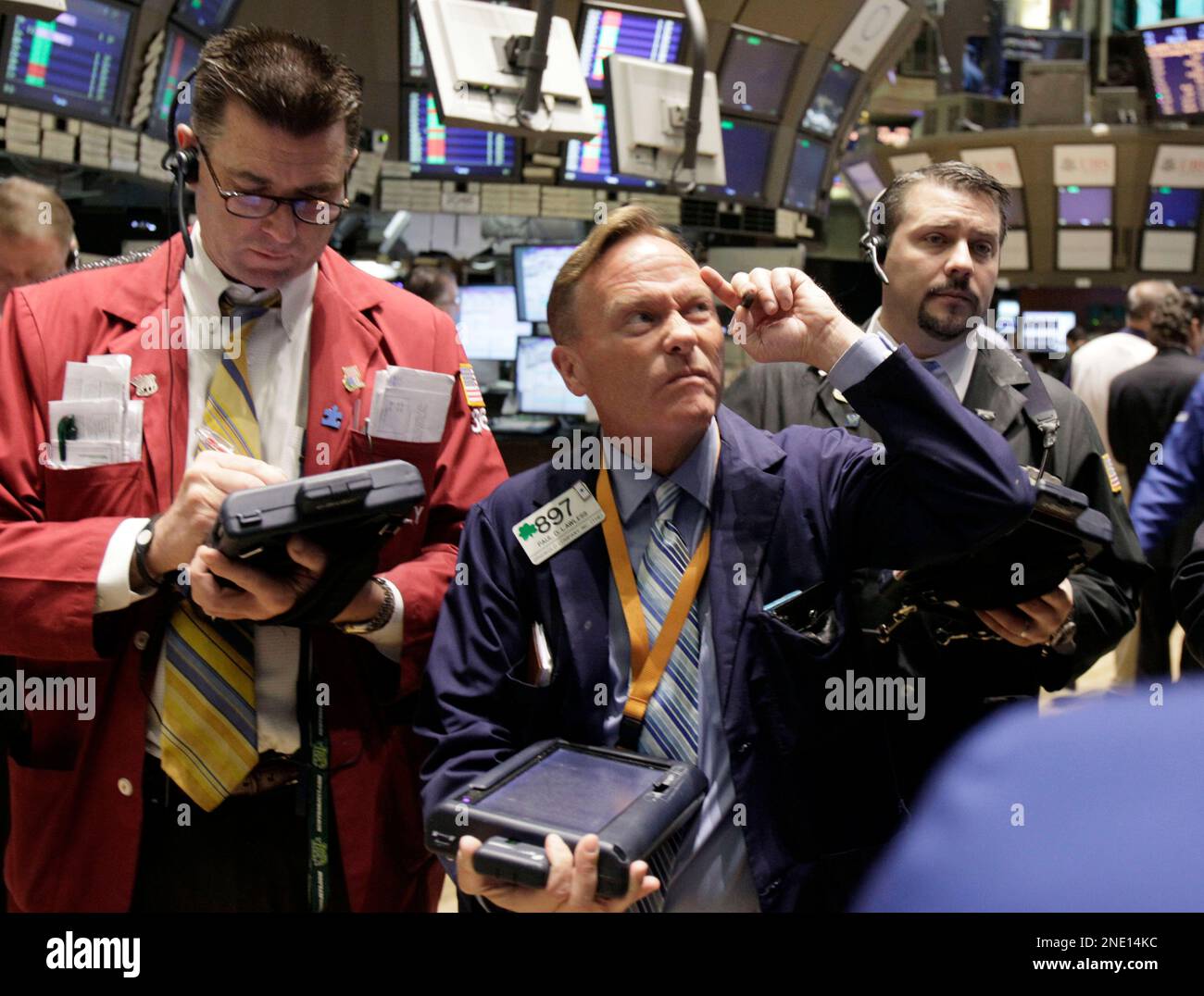 Trader Paul Lawless, center, works on the floor of the New York Stock ...