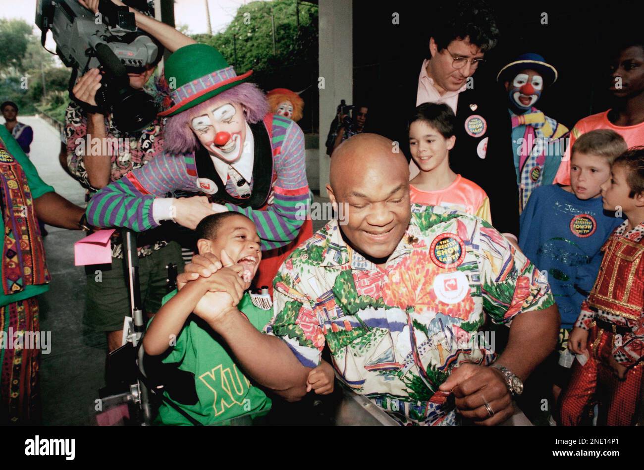 Boxing champion George Foreman greets Michael Seale, 9, during a ...
