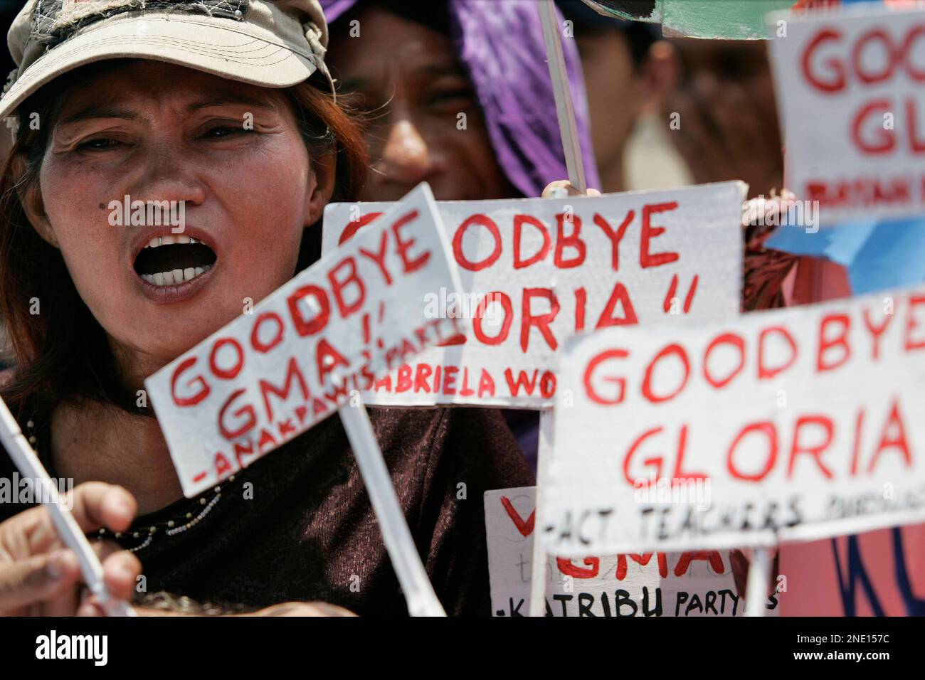 Filipino activists shout beside slogans on a mock cake to mark the 63rd ...