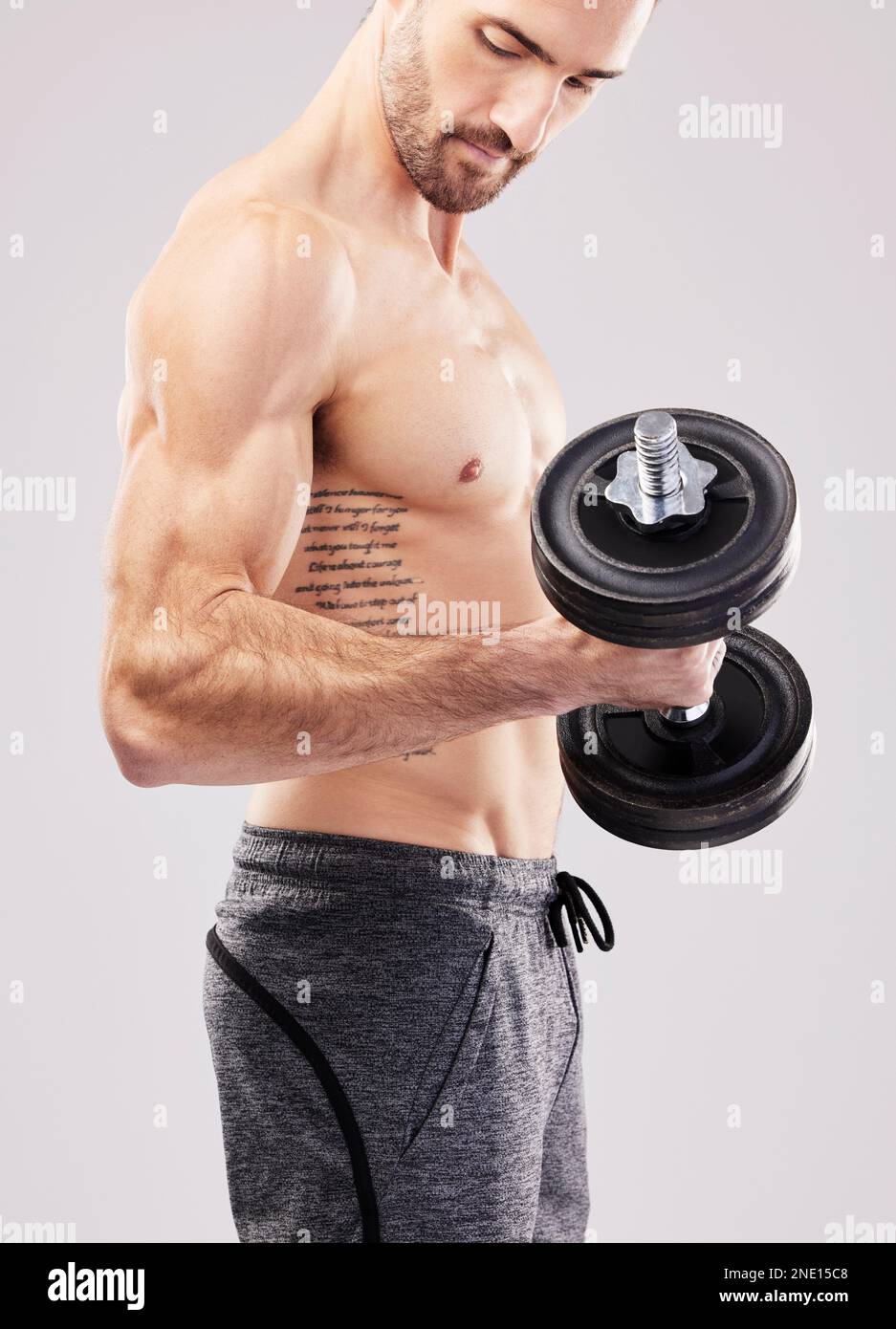 Arm training, dumbbell and bodybuilder man workout in a studio for ...