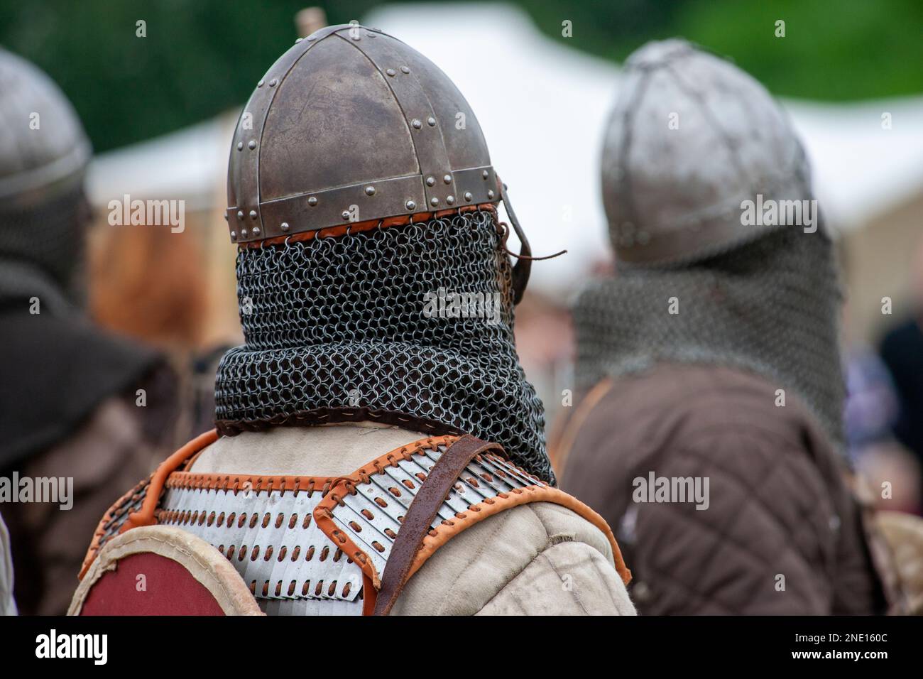 A closeup of a Viking attire and helm on a person standing in a line ...