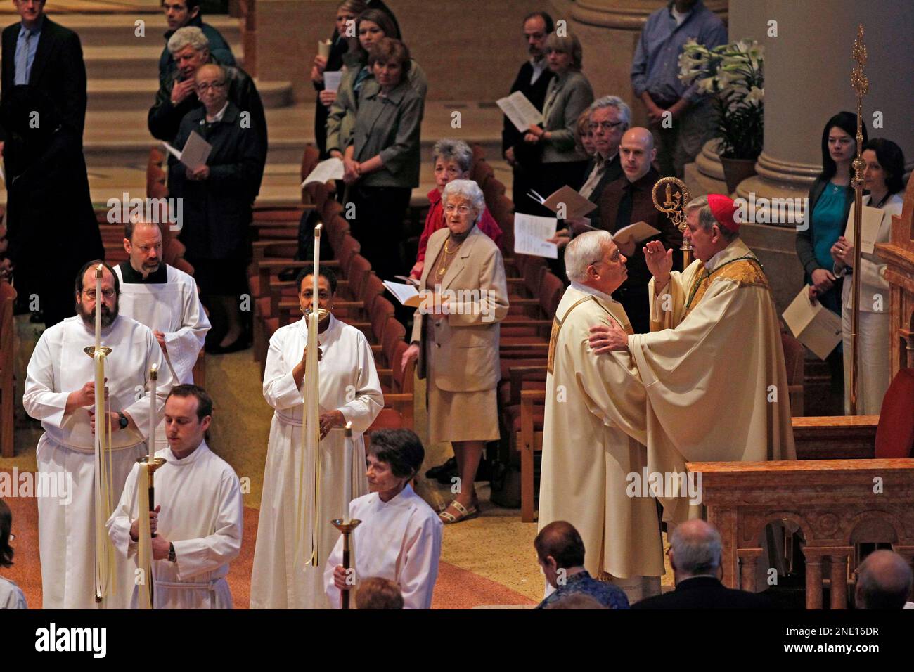 Archbishop of Milwaukee Jerome E. Listecki, right, blesses a priest ...