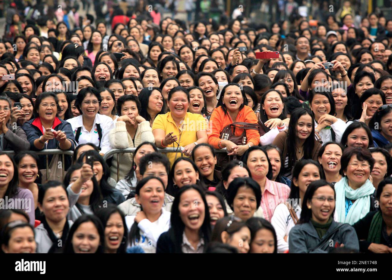 Philippine residents in Hong Kong react as they attend an Easter Sunday ...