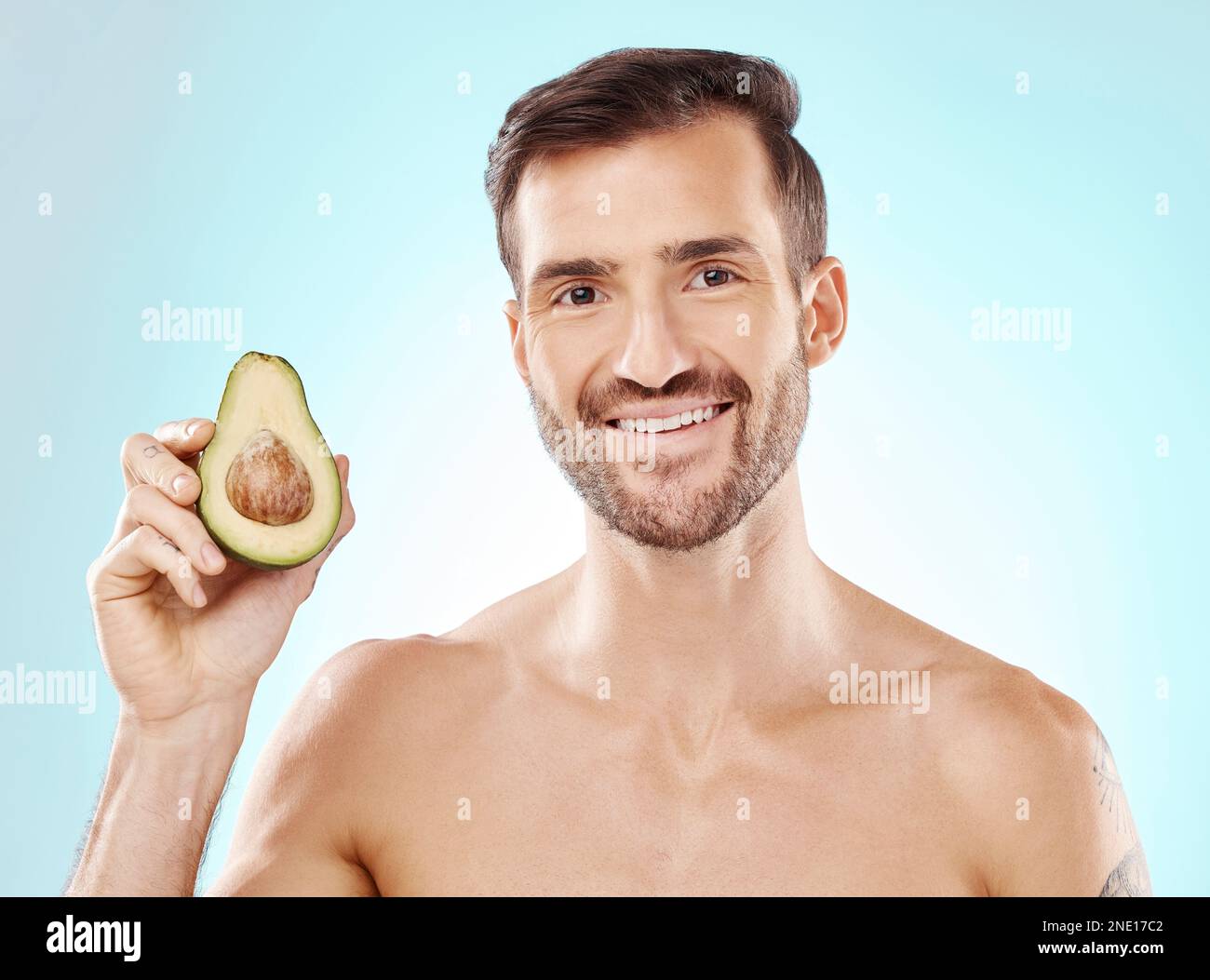 Man, skincare and studio portrait with avocado for health, nutrition ...