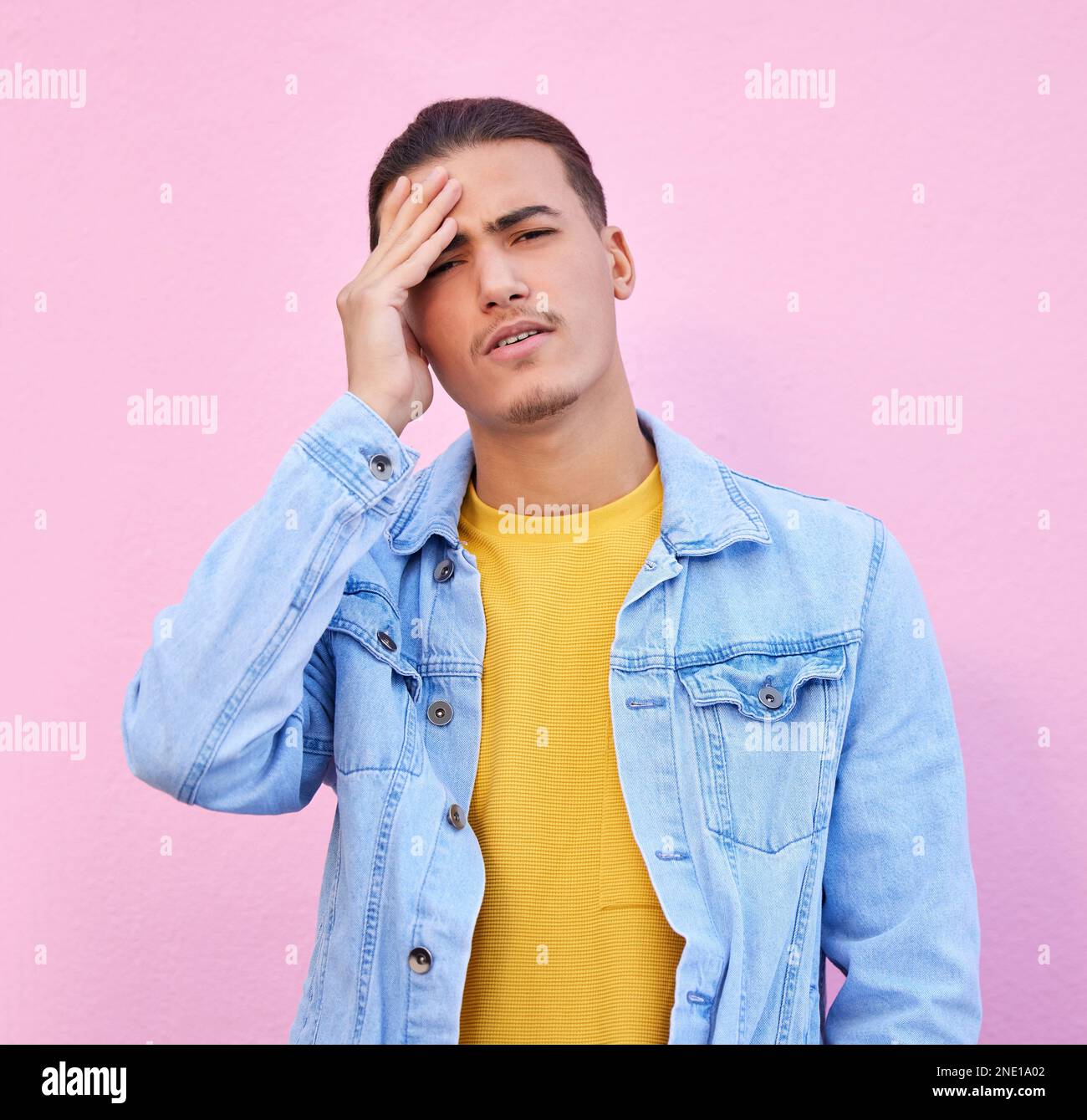 Stress, portrait and man with headache in studio isolated on a pink ...